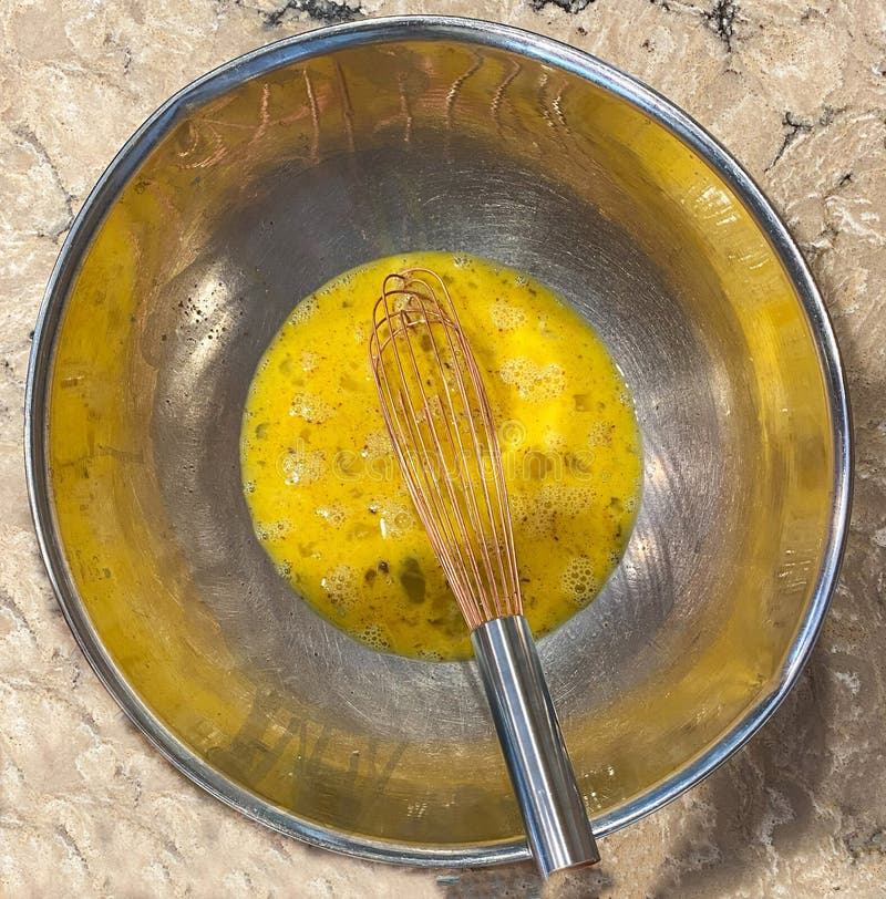 A Shiny Metal Bowl with a Whisk Amd Eggs Ready for Baking Stock Photo ...