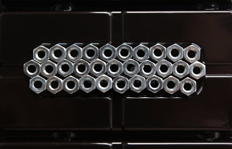 Shiny Metal Nuts in Rectangular Order on Plastic Surface Stock Photo ...