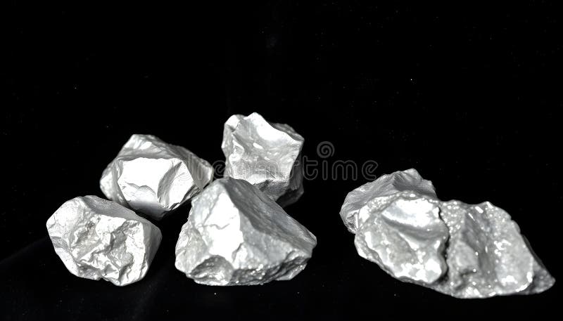 Shiny Metallic Rocks on a Dark, Reflective Surface Display Stock ...
