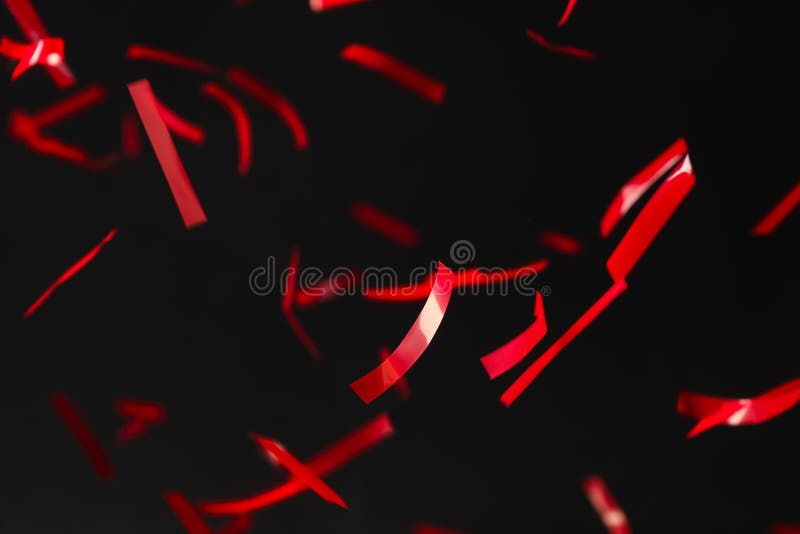 Shiny Red Confetti Falling Down on Black Background Stock Photo - Image ...