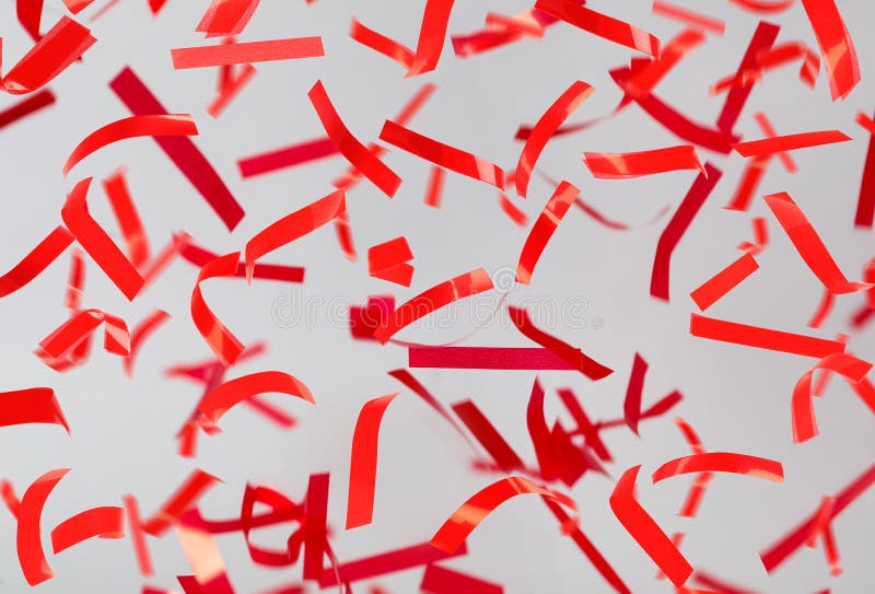 Shiny Red Confetti Falling Down on Light Grey Background Stock Photo ...