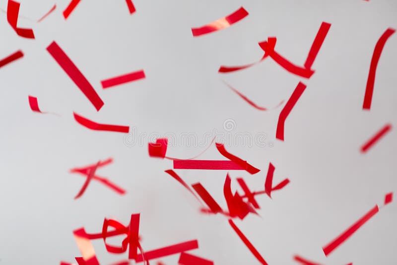 Shiny Red Confetti Falling Down on Light Grey Background Stock Photo ...