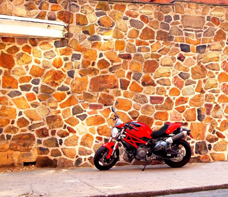 Shiny Red Motorcycle Parked by Stone Wall Stock Photo - Image of stone ...