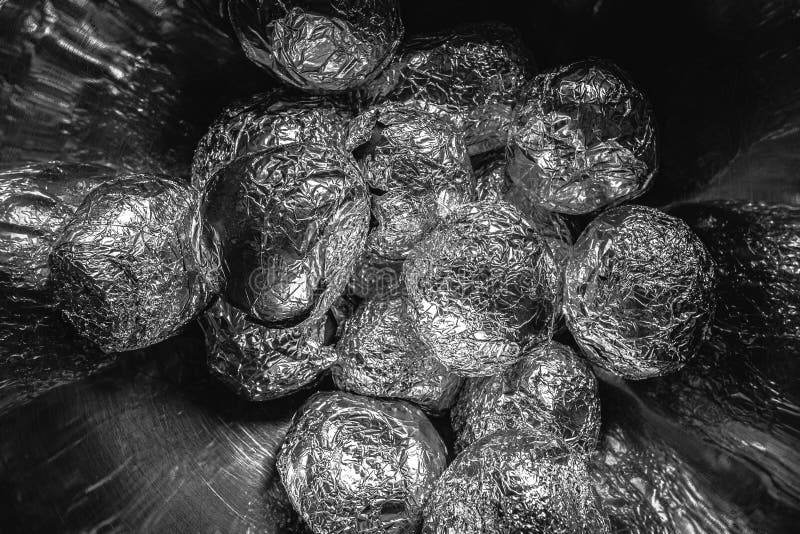 Shiny Round Objects Wrapped in Foil in Black and White Image Stock ...
