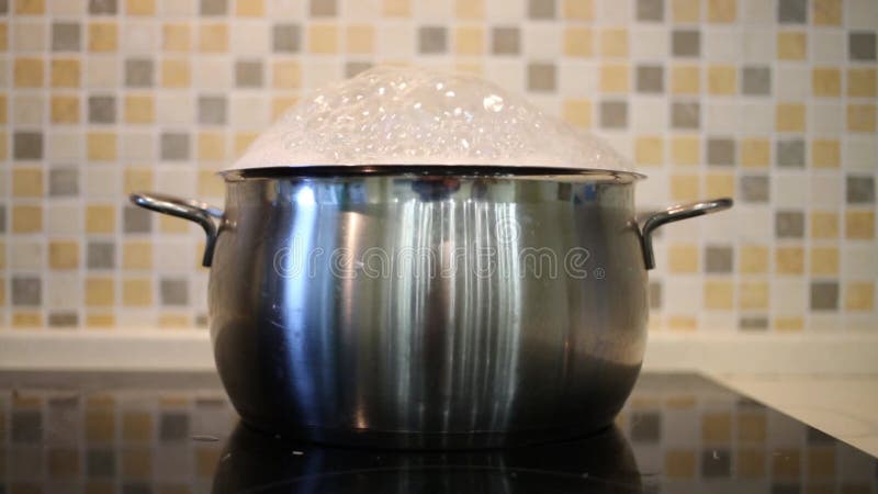 Shiny Saucepan of Boiling Water on Stove in Stock Footage - Video of ...