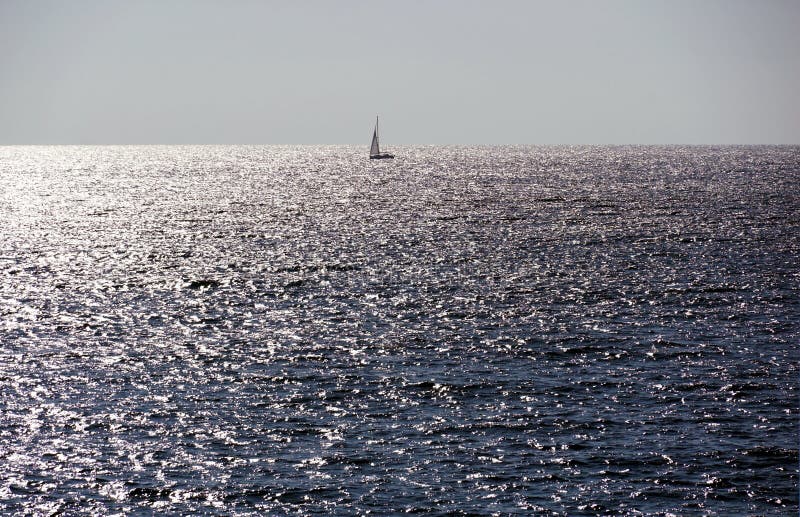 Shiny Sea Horizon with Sailing Yacht and Silver Shining Waves Stock ...