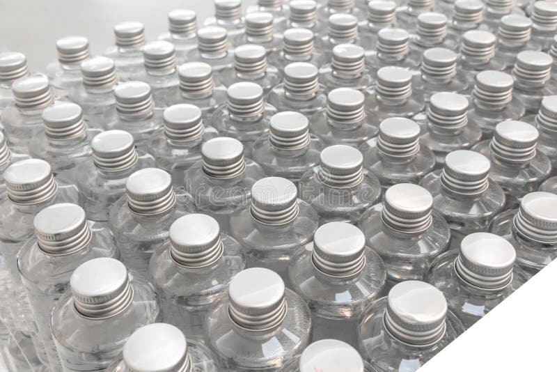 Shiny Silver Caps of Clear Plastic Bottles in Rows for Pattern B Stock ...