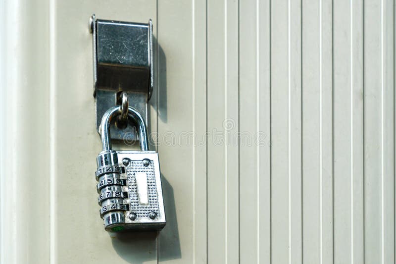 Close-Up of Metal Combination Padlock Securing a Beige Door with ...