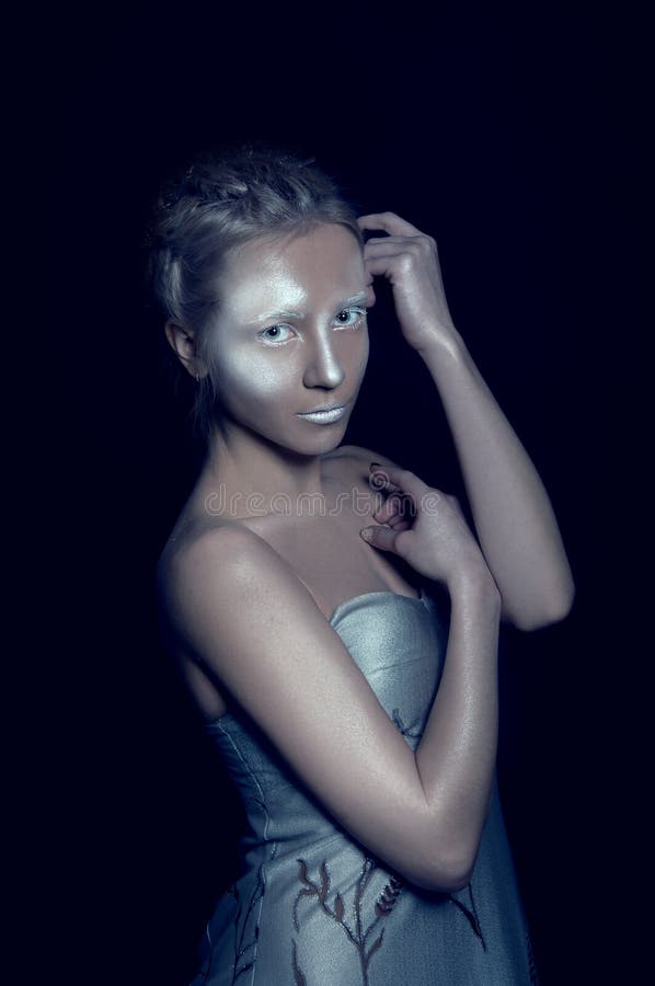 Shiny silver lady in dark stock photo. Image of beauty - 49436652
