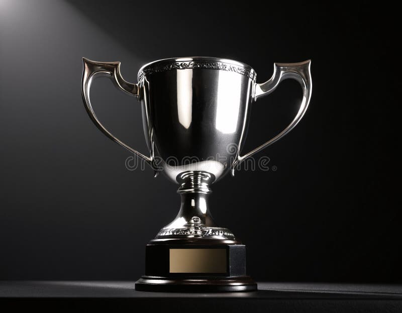 A Shiny Silver Trophy with Two Handles and a Gold Plaque Stands on a ...