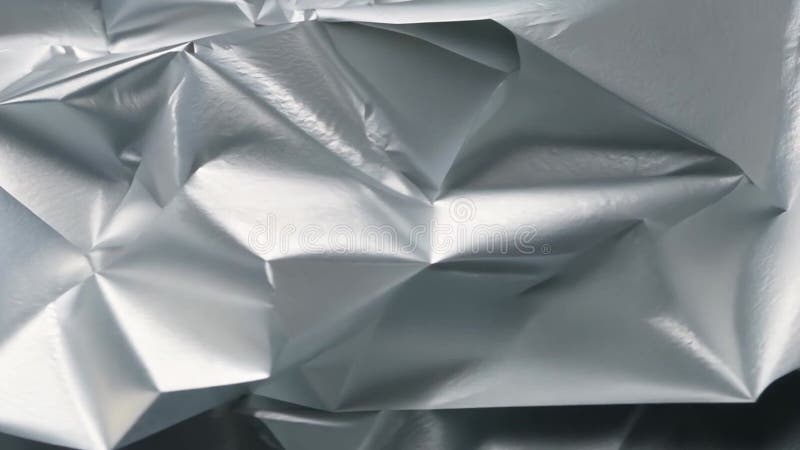 Shimmering Crumpled Aluminum Foil Texture Reflecting Light in an ...