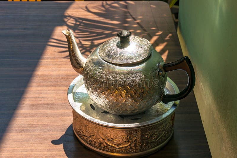 Shiny Teapot on the Table Outdoors Stock Image - Image of table, shadow ...