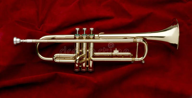 Shiny trumpet on red suede stock photo. Image of three - 10256940