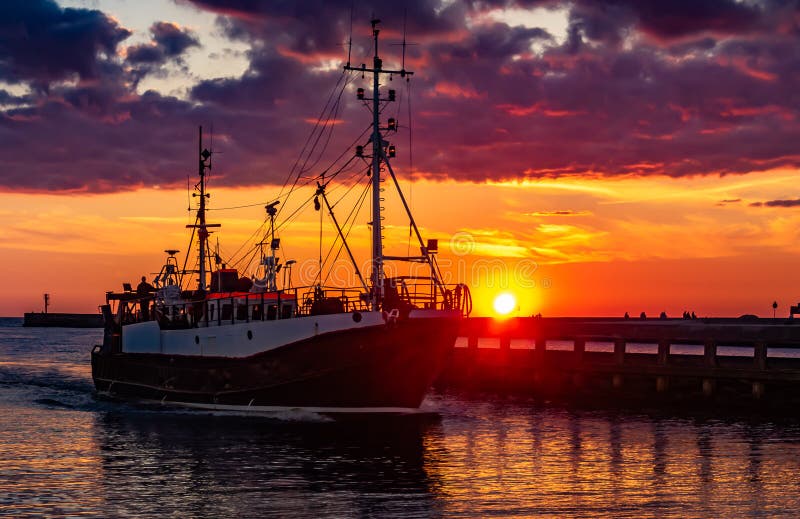 A Ship Entering Port at Sunset Stock Image - Image of orange, twilight ...