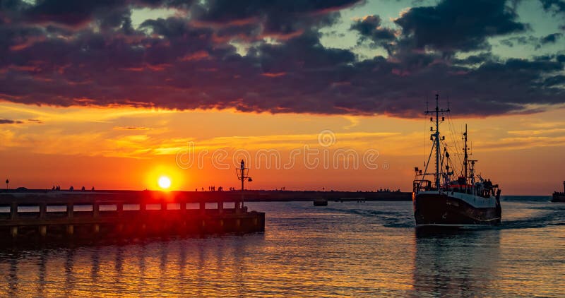 A Ship Entering the Port at Sunset in Ustka Stock Photo - Image of ...