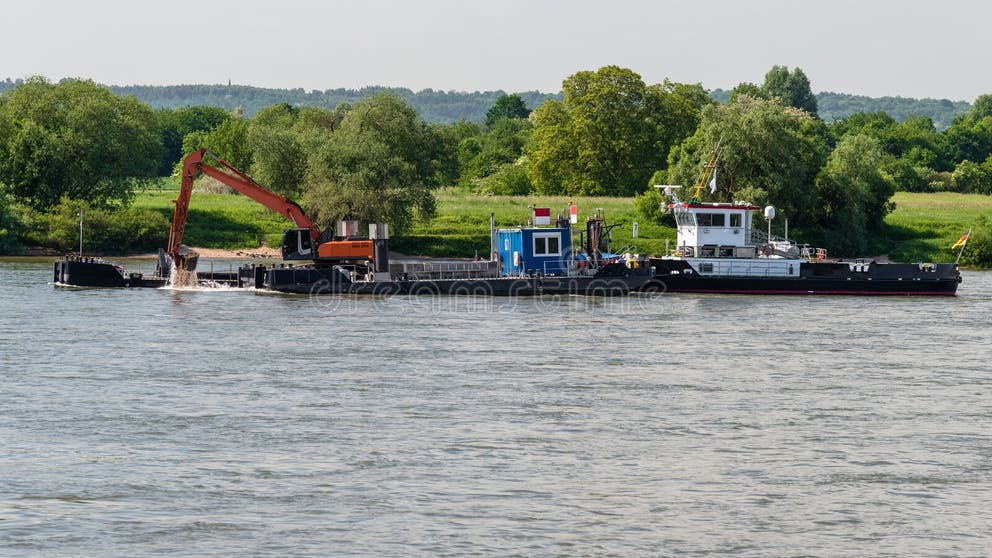 Ship with Excavator Deepening the Bottom of the River. Stock Image ...