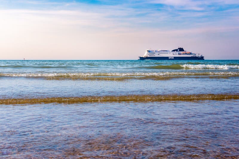Ship Ferry DFDS Seaways. Dramatic Sky and Blue Water Waves. Surfer ...