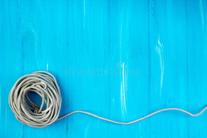 Ship Rope Knot on Blue Wooden Texture Background. Top View Stock Photo ...