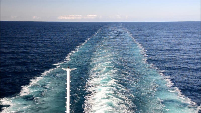 A Foaming Wake of a Ship Cuts through the Vast Blue Ocean Under a ...