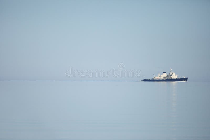 Ship Sails Across a Calm, Endless Sea Under a Pale Blue Sky Stock Photo ...