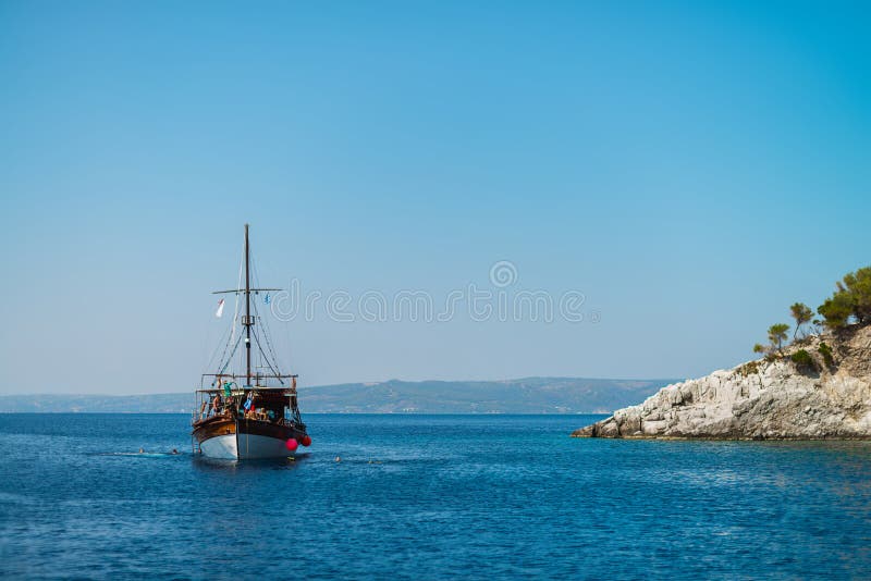 Ship on the sea by rocks stock image. Image of landmark - 33799839