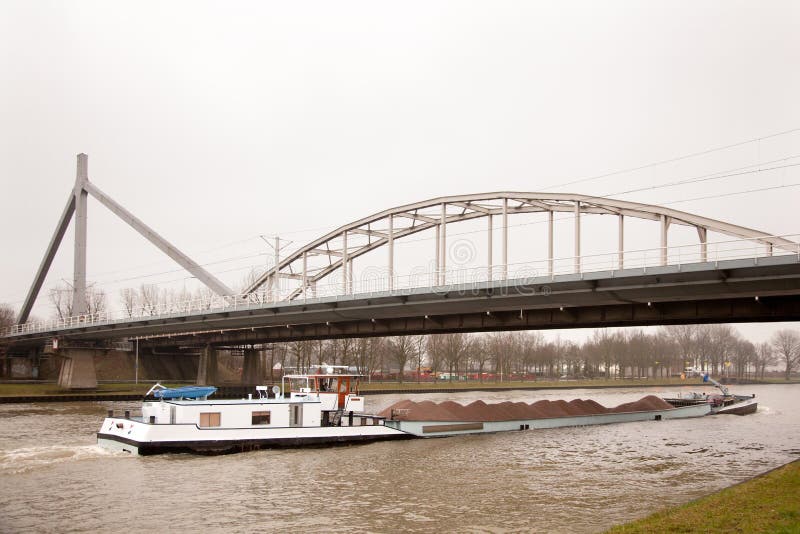 Ship Transporting Sand Under Bridge in Holland Stock Photo - Image of ...