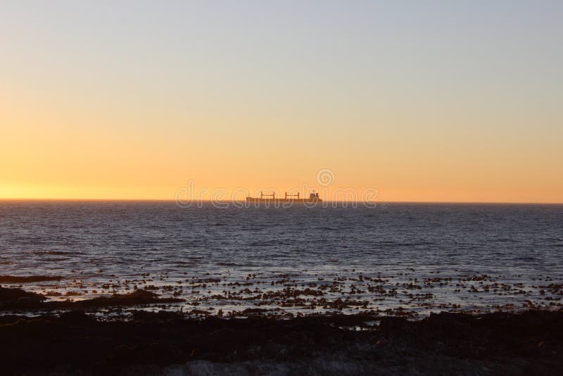 Ship In The Water With Sunset Over The Horizon Stock Image - Image of ...