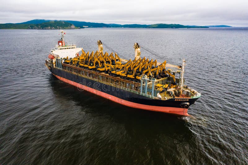 Shipment of Excavators and Other Equipment on the Deck of a Cargo Ship ...