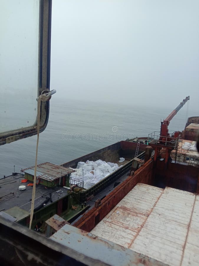 Ships Unloading Cargo in the Middle of the Sea Stock Photo - Image of ...