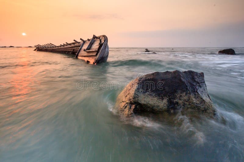 A Shipwreck with Rock Stone at the Beach Stock Photo - Image of small ...