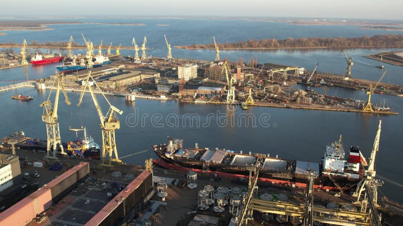 Shipyard Aerial View: Cranes, Ships and Industrial Scene at Sunset ...