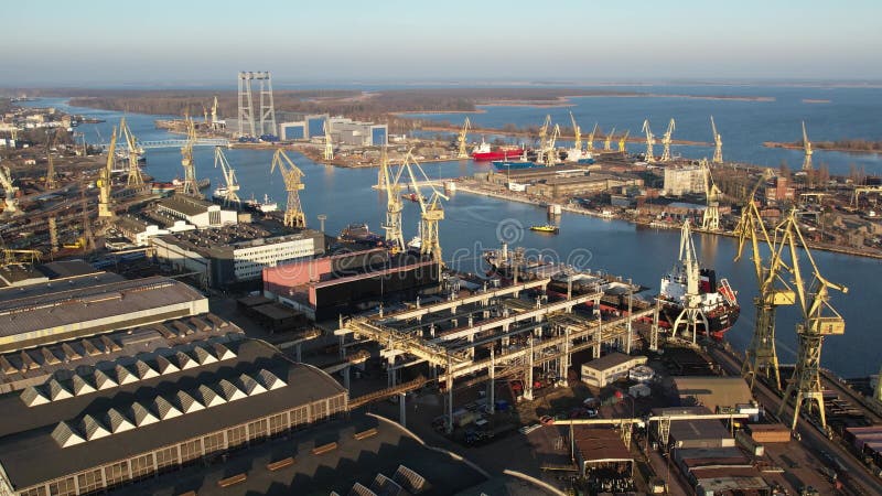 Shipyard Aerial View: Cranes, Ships and Industrial Scene at Sunset ...
