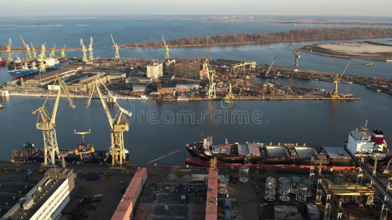 Shipyard Aerial View: Cranes, Ships and Industrial Scene at Sunset ...