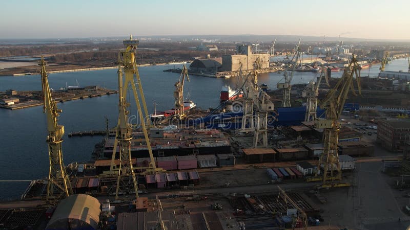 Shipyard Aerial View: Cranes, Ships and Industrial Scene at Sunset ...