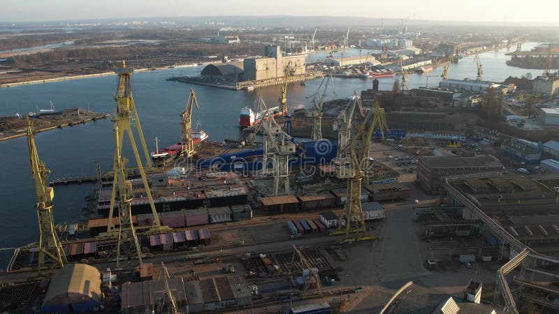 Shipyard Aerial View: Cranes, Ships and Industrial Scene at Sunset ...