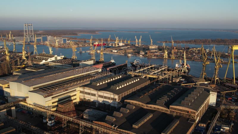 Shipyard Aerial View: Cranes, Ships and Industrial Scene at Sunset ...
