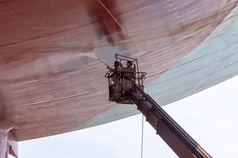 Shipyard Workers Cleaning Ships Hull. Ship in a Dry Dock. Stock Photo ...