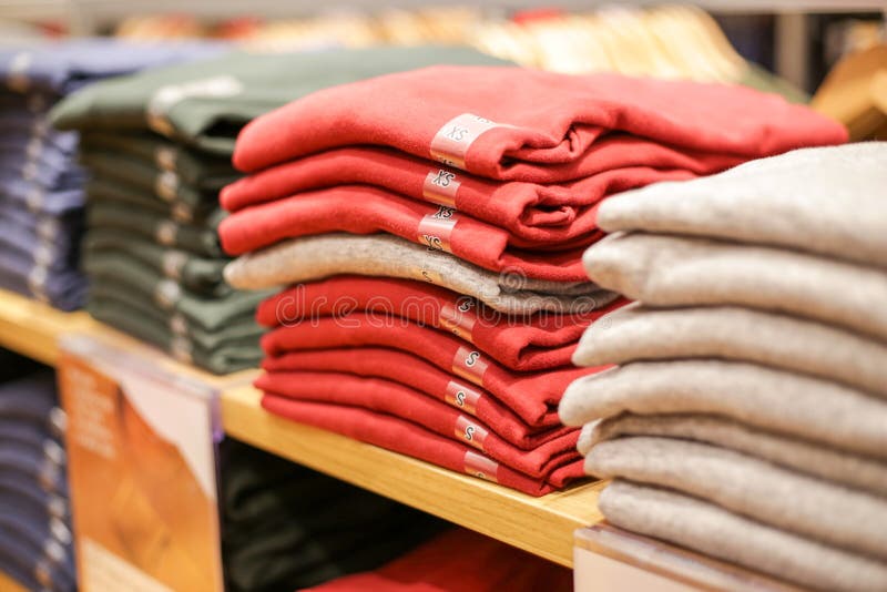 Shirt Light in a Stack with Red T-shirts Spread Out on a Shelf with ...