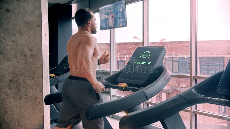 Shirtless Attractive Man Bodybuilder Running on the Treadmill Stock ...