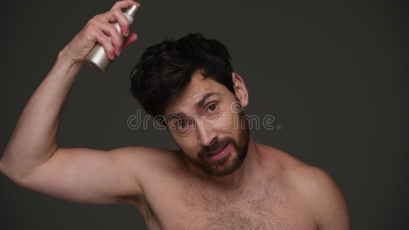 Shirtless and Disheveled Man Using Hairspray and Smiling Isolated on ...