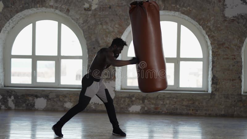 Shirtless Male Boxer Training at Boxing Studio with Wrapped Hands, Rear ...