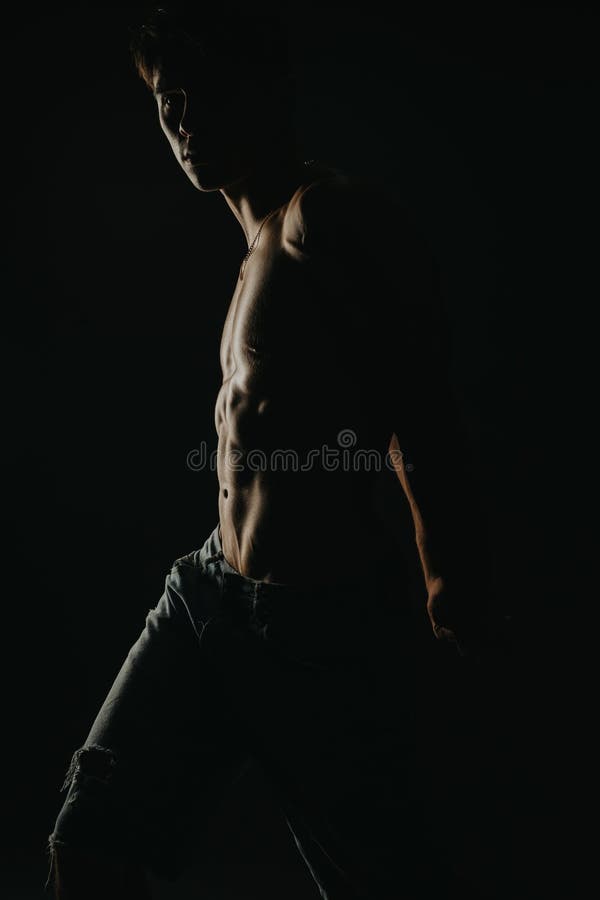 Dramatic Shirtless Male with Defined Abs in Moody Low Light and Dark ...
