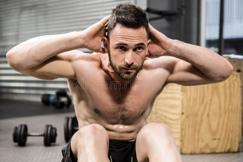 Shirtless Man Doing Abdominal Crunches Stock Photo - Image of hands ...