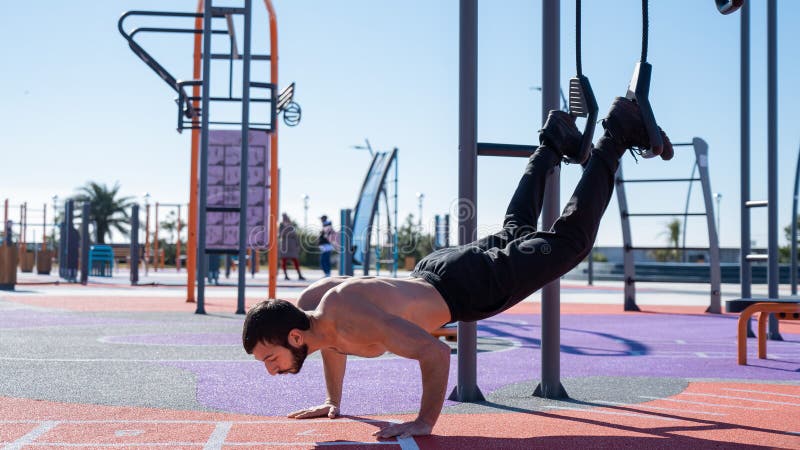 Shirtless Man Doing Loop Exercises Outdoors. Stock Photo - Image of ...