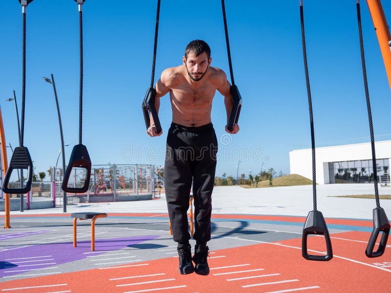 Shirtless Man Doing Loop Exercises Outdoors. Stock Photo - Image of ...