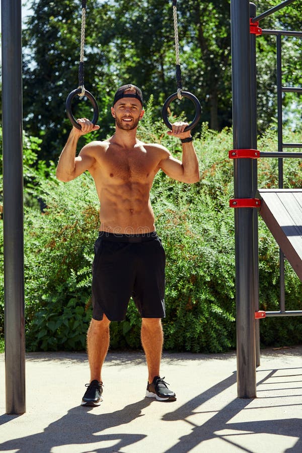 Shirtless Man Doing Loop Exercises Outdoors in Summer Park. Stock Image ...