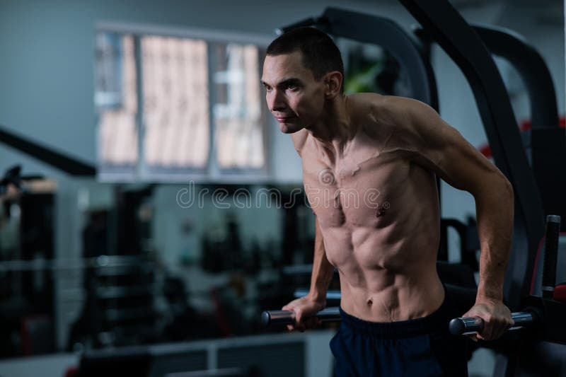 Shirtless Man Doing Triceps Dips from Parallel Bars in Gym. Stock Photo ...