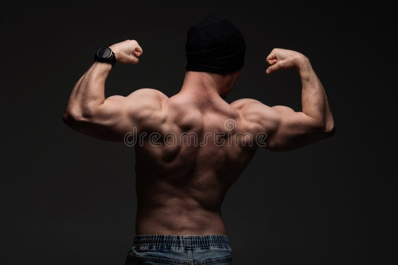 Shirtless Man Flexing Back Muscles, Powerful Pose Under Moody Lighting ...
