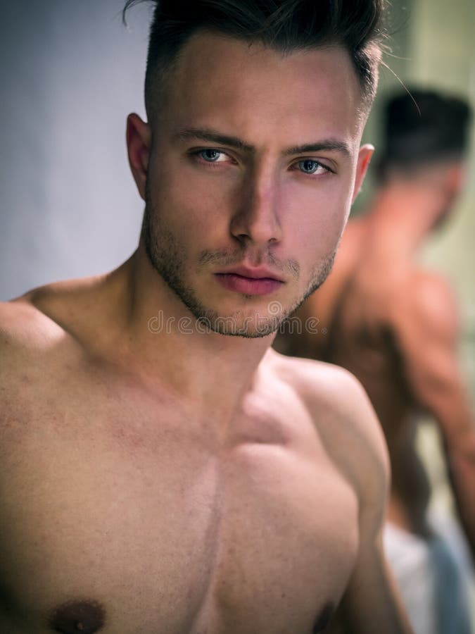 Photo of a Shirtless Man Admiring Himself in the Mirror Stock Photo ...