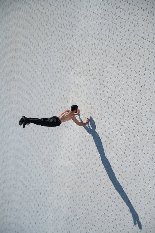 Shirtless Man Walks on His Hands Outdoors. View from Above. Stock Photo ...